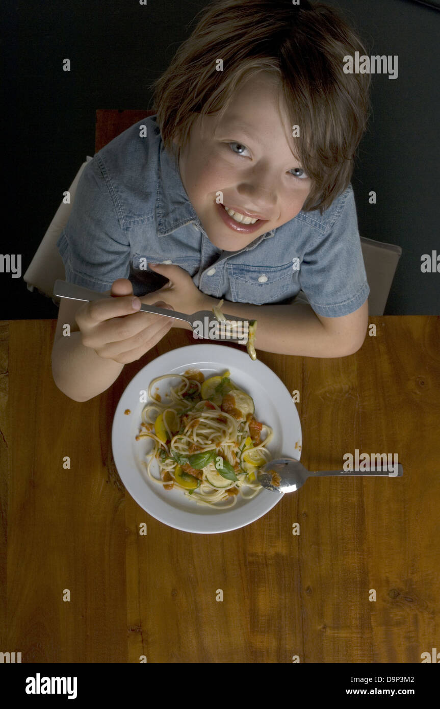 Boy eating pasta with vegetable Stock Photo - Alamy