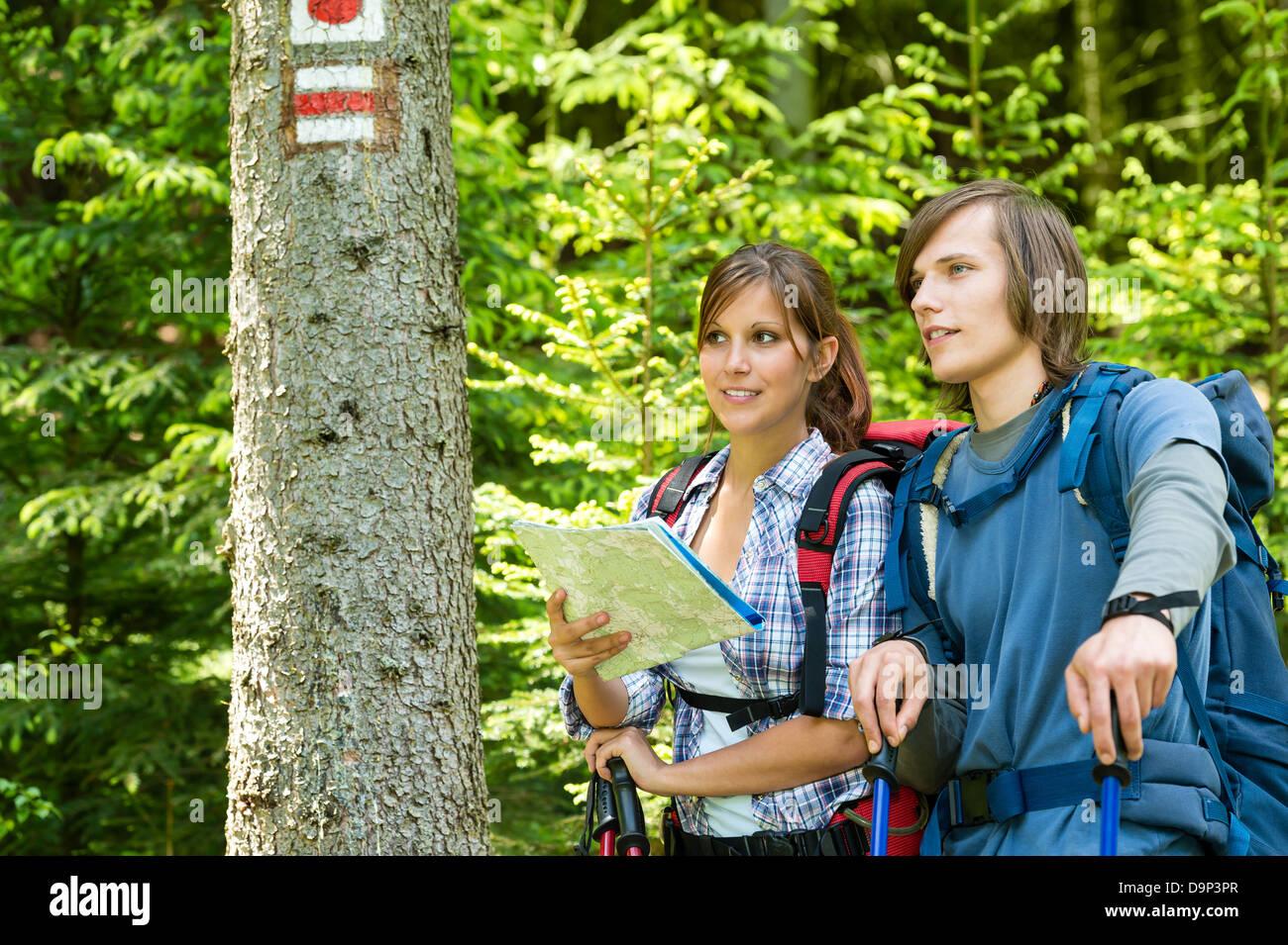 Young tourist hikers checking the map and blaze Stock Photo - Alamy