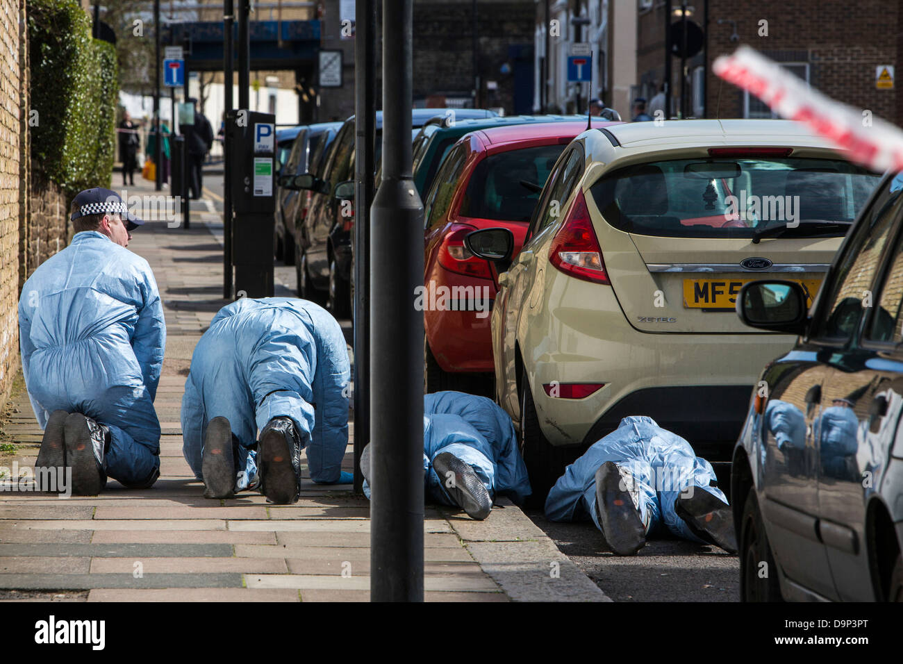 In blue protection suits forensic police search Cambria Road ...