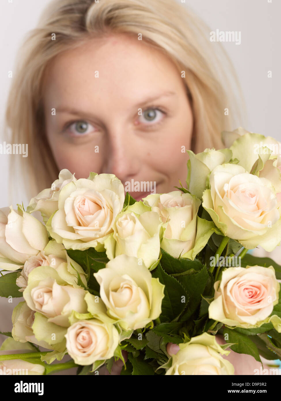 Woman with bunch of flowers Stock Photo - Alamy