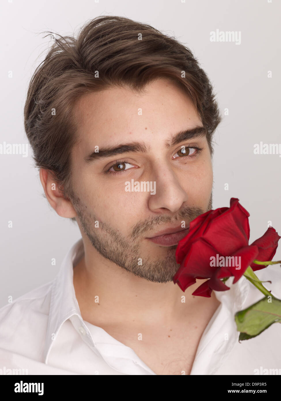 Man smelling at red rose Stock Photo - Alamy