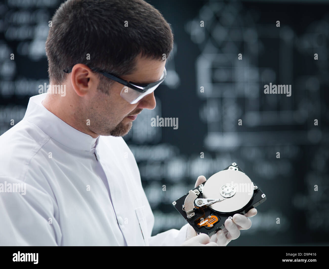close-up of a scientist in a chemistry lab analyzing a hard disk Stock ...