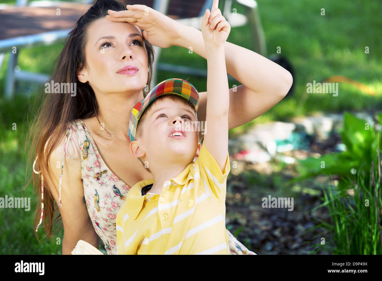 Little son showing his pretty mom something interesting Stock Photo - Alamy