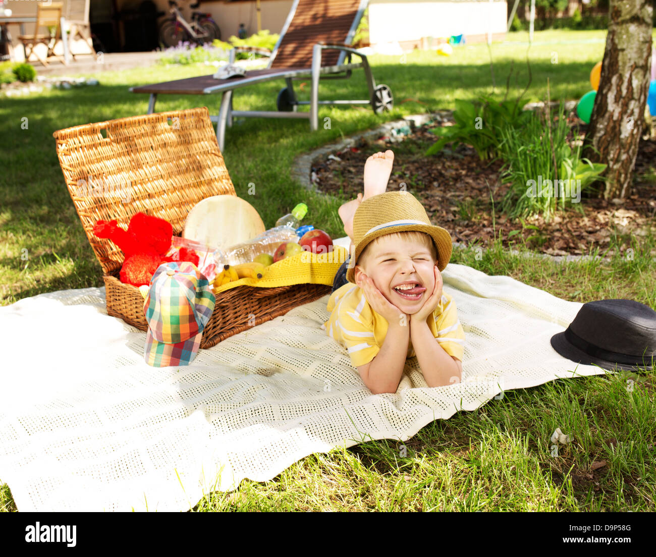 laughing kid resting next to the wicker basket Stock Photo - Alamy