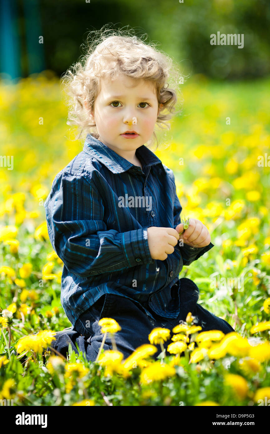 little boy in flowers field Stock Photo - Alamy