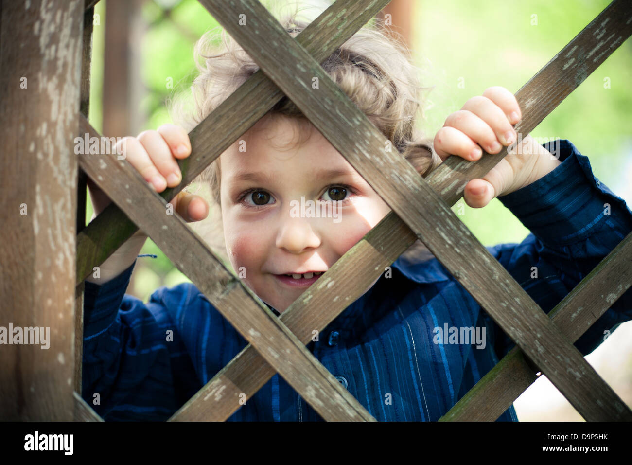 little boy behind the fence Stock Photo - Alamy