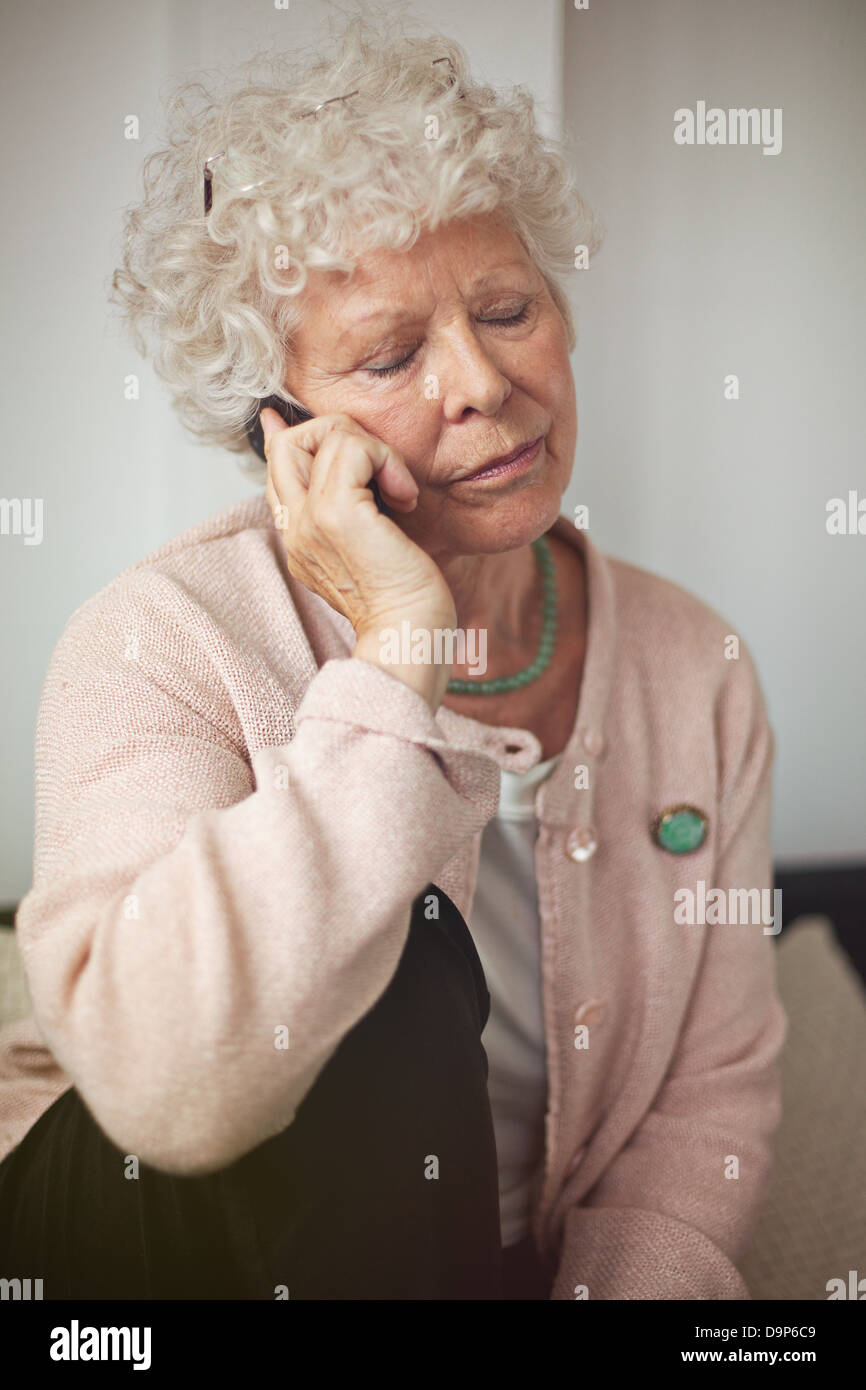 Pensioner woman sad talking phone hi-res stock photography and images ...