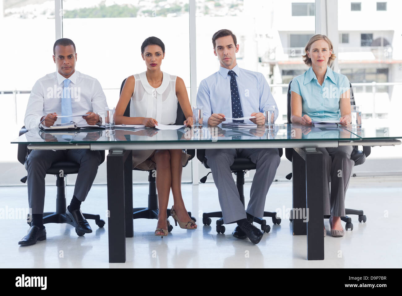 Group of business people sat in line Stock Photo - Alamy