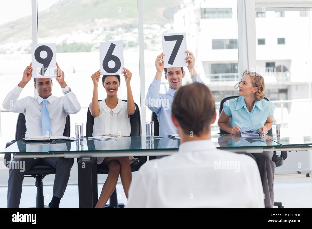 Jury giving marks to an applicant Stock Photo - Alamy