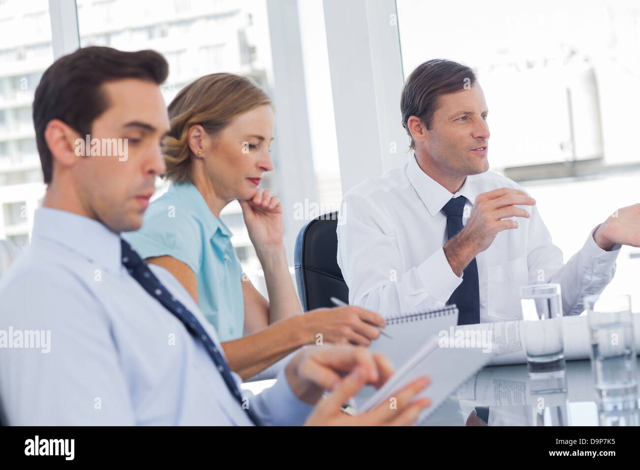 Three business people during a meeting Stock Photo - Alamy