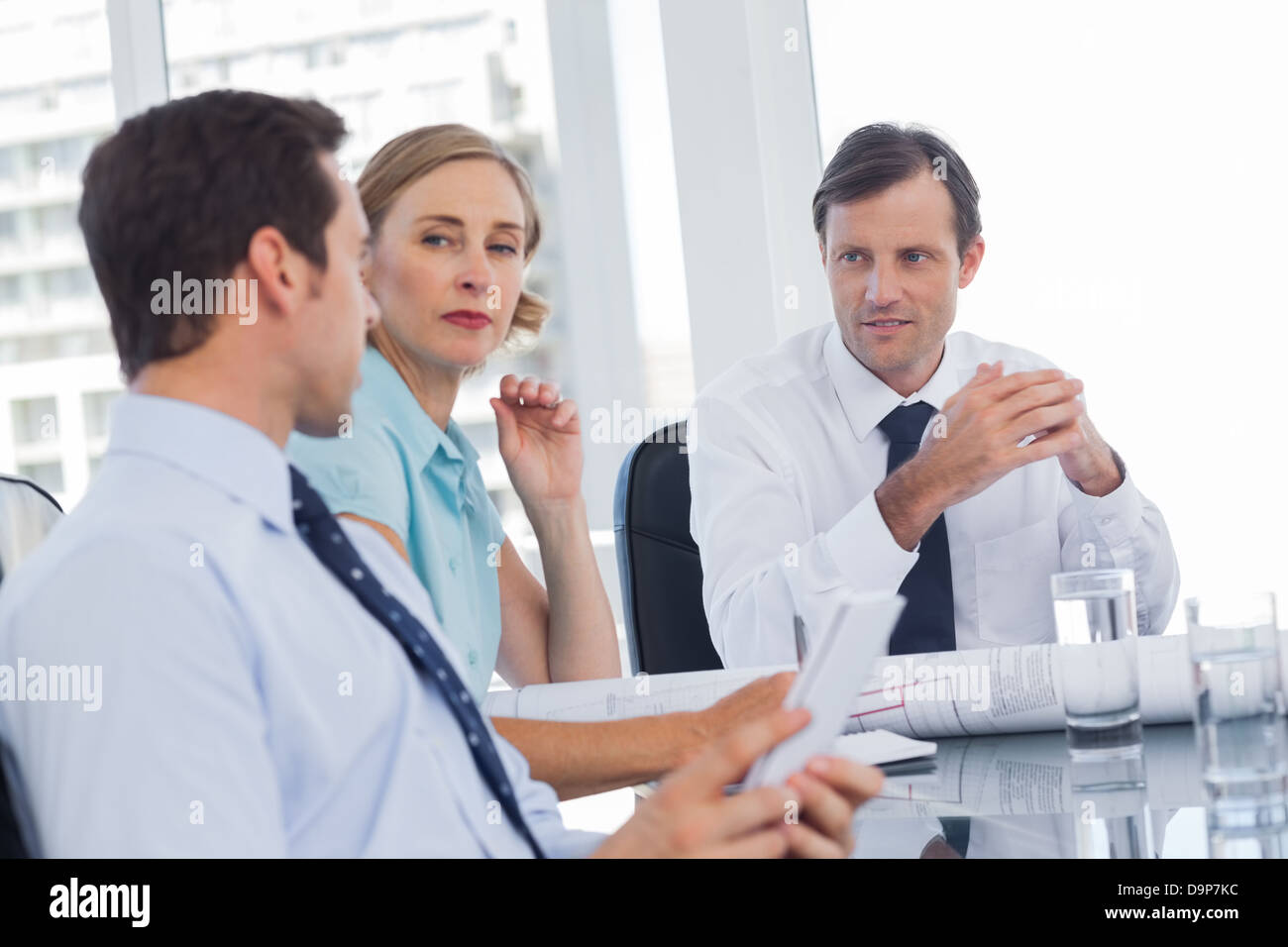 Three serious business people Stock Photo - Alamy