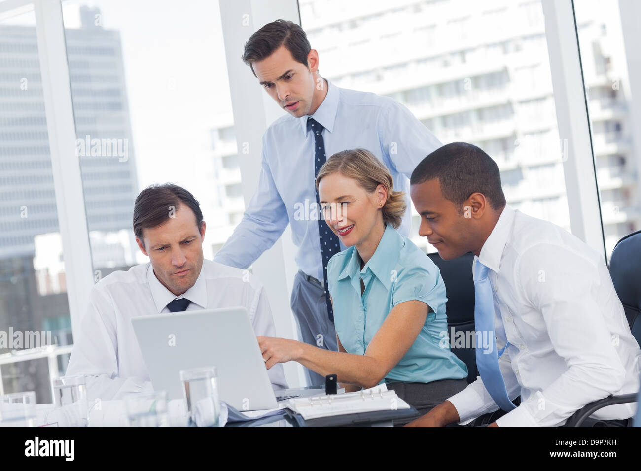 Four business people in a meeting room Stock Photo - Alamy