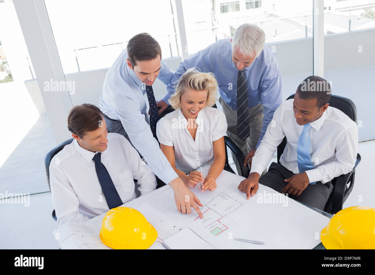 Architects looking at blueprints Stock Photo - Alamy