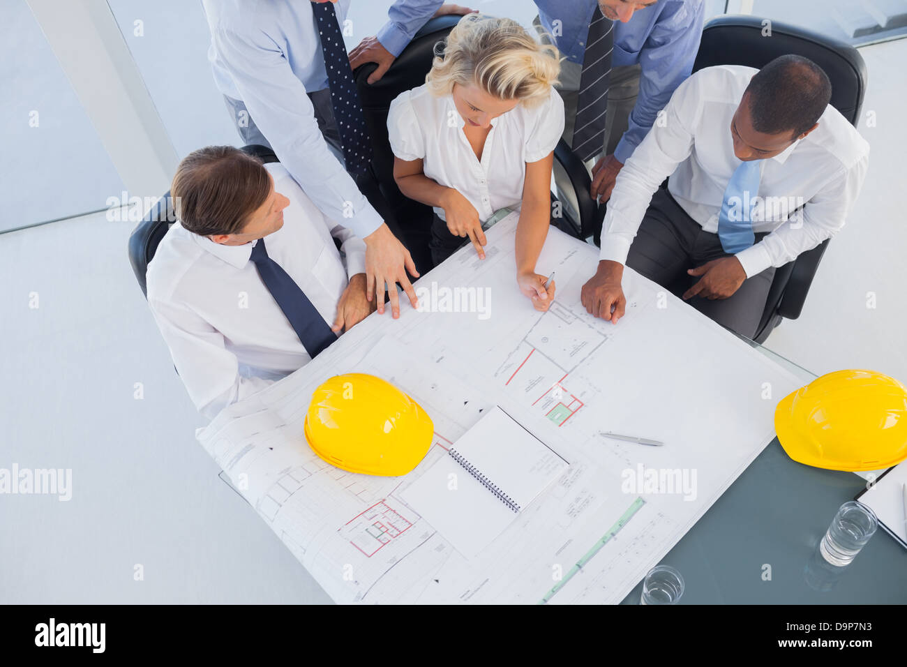 Business people working on construction plan Stock Photo - Alamy