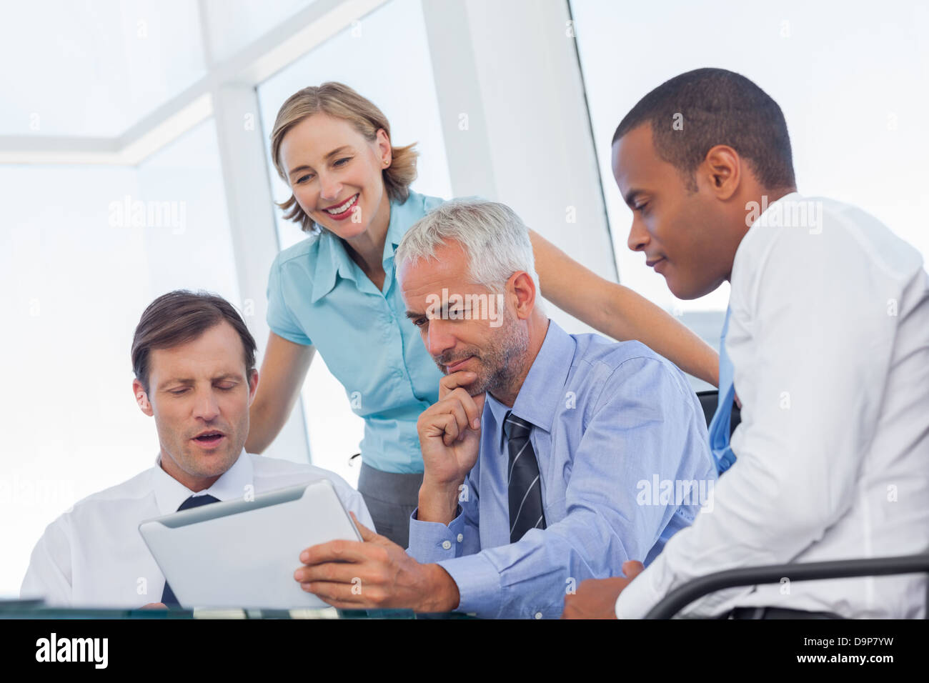 Business people looking at a digital tablet Stock Photo - Alamy
