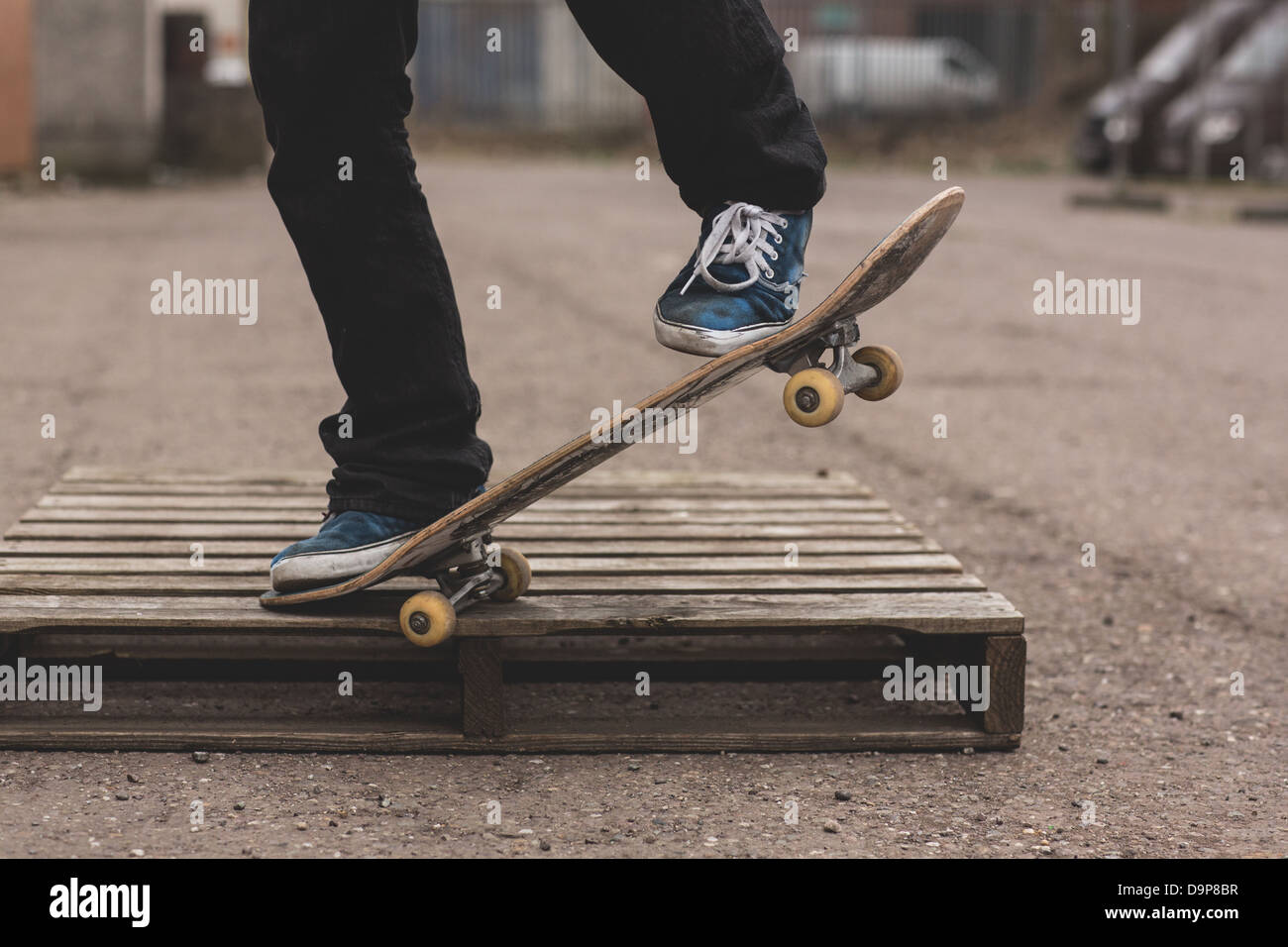Skater doing manual trick on wooden crate Stock Photo - Alamy