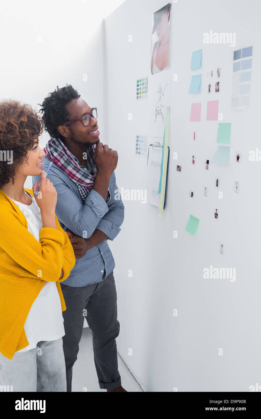 Smiling designers standing in front of material samples Stock Photo - Alamy