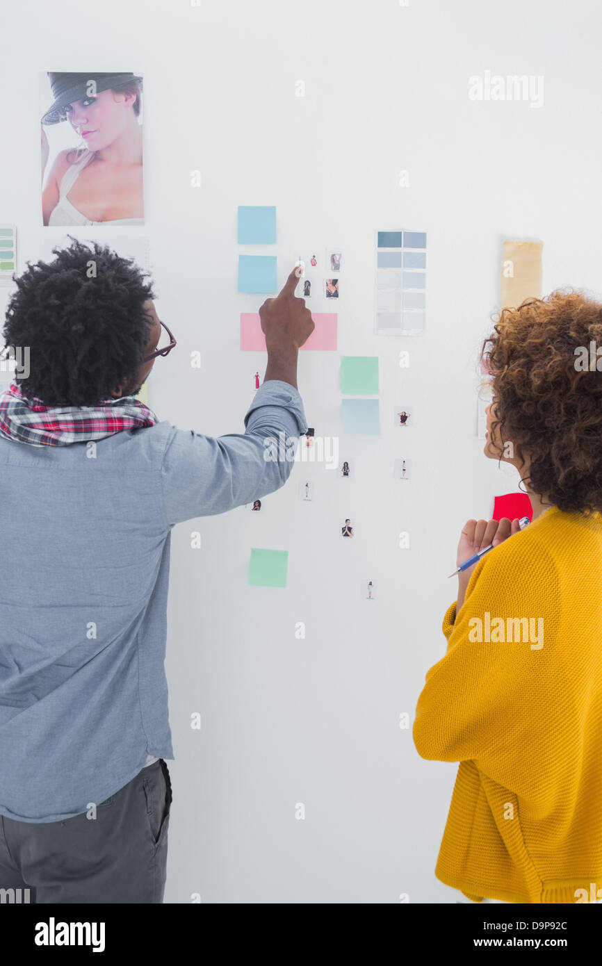 Designers pointing at a group of photos Stock Photo - Alamy