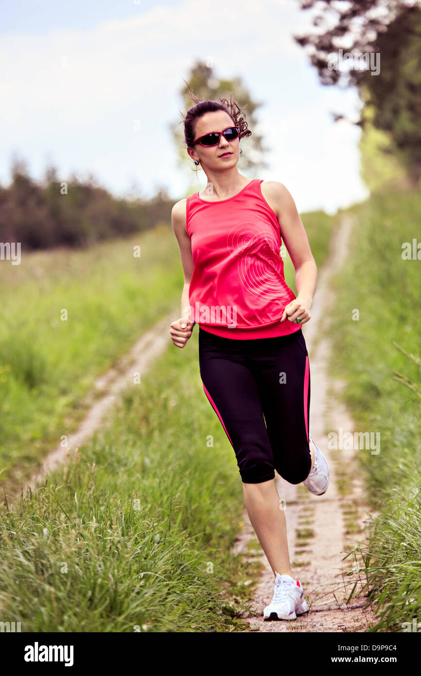 young woman jogging in front of rural landscape Stock Photo - Alamy