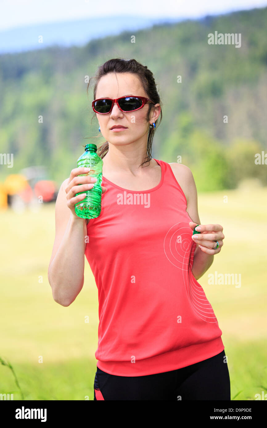 A woman taking a break from running Stock Photo - Alamy