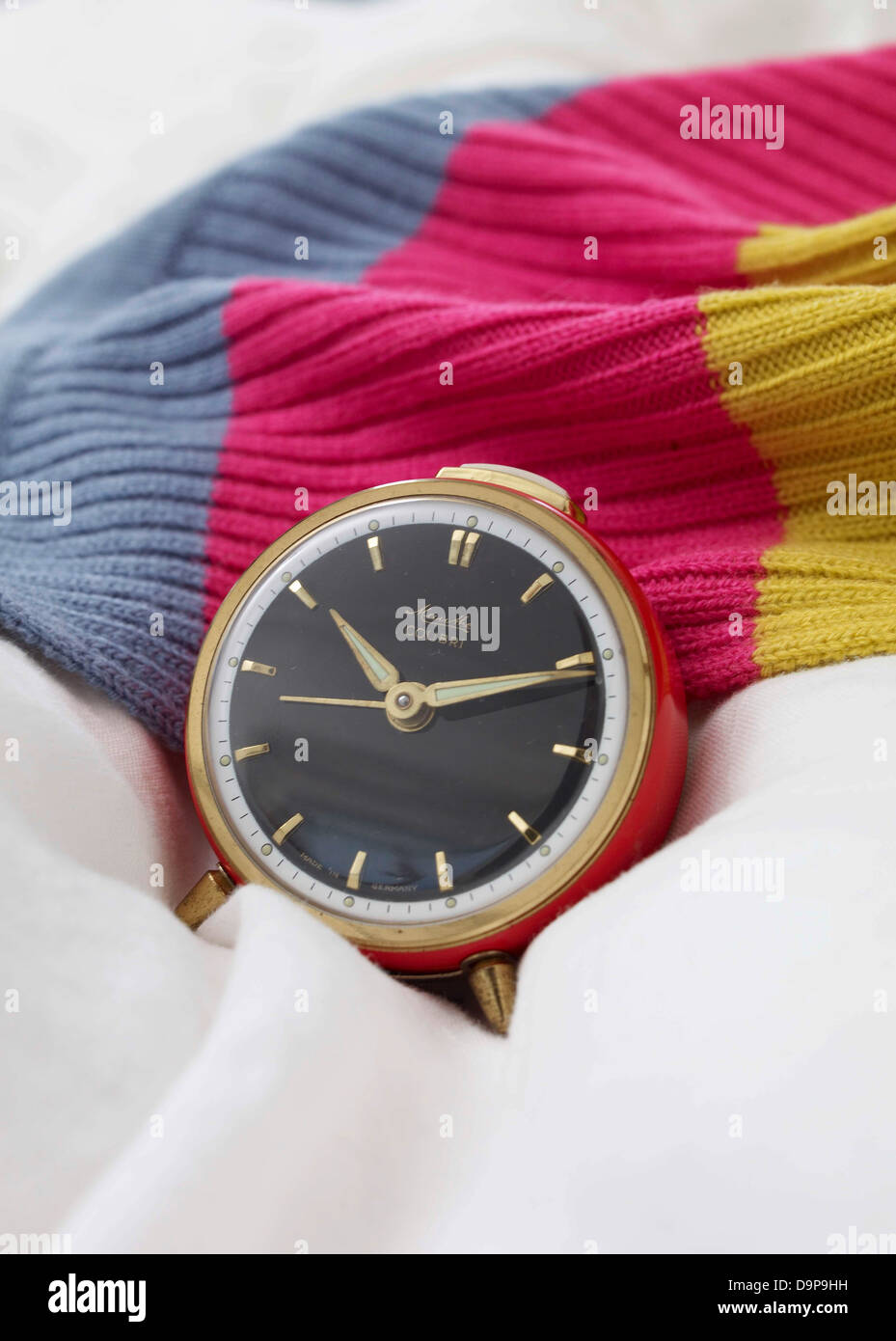 Alarm clock and blanket on bed Stock Photo - Alamy