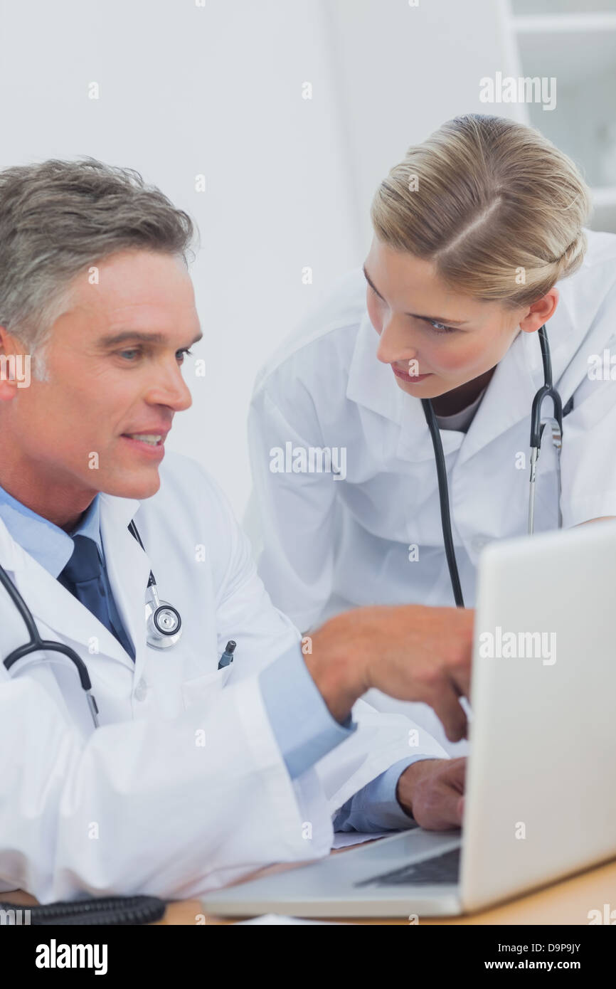 Smiling mature doctor pointing hi-res stock photography and images - Alamy