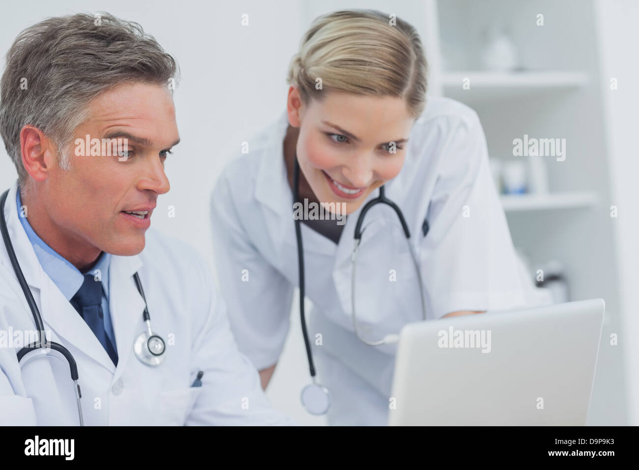 Two doctors watching a laptop Stock Photo - Alamy