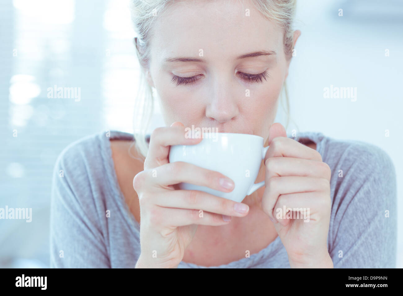 Woman sipping tea hi-res stock photography and images - Alamy