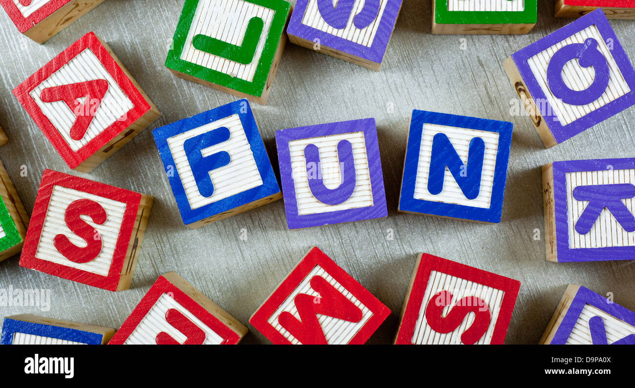 Wooden blocks forming the word FUN in the center Stock Photo - Alamy