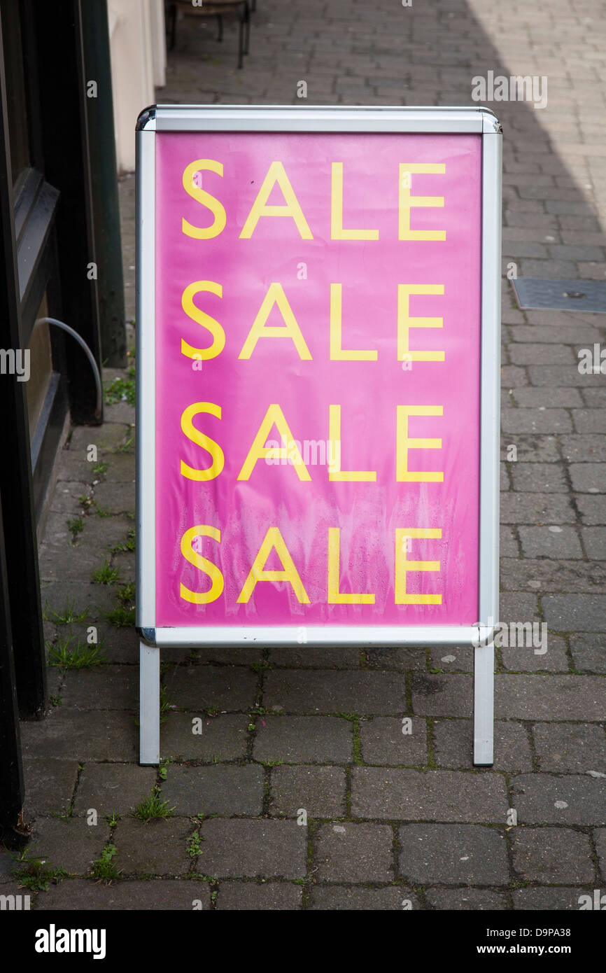 Sale sign of yellow text on a pink background outside a shop Stock ...