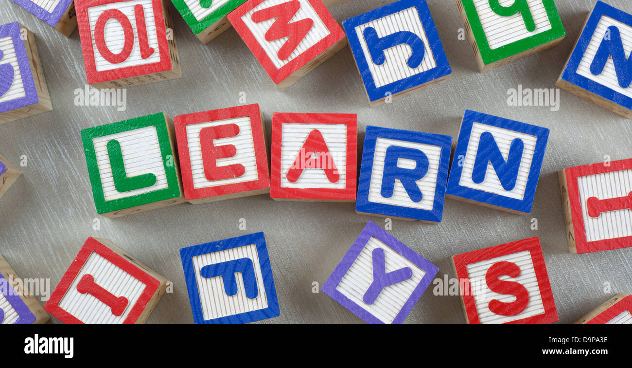 Wooden blocks forming the word LEARN in the center Stock Photo - Alamy