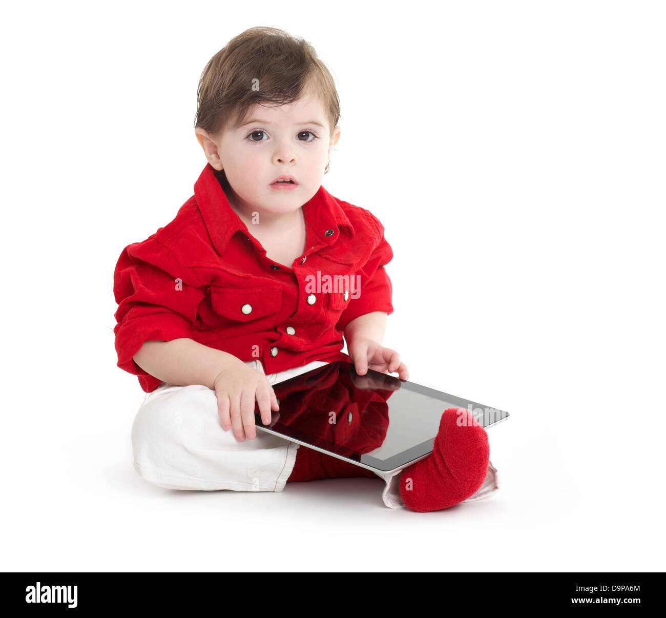 Toddler baby sitting and using with tablet Stock Photo - Alamy