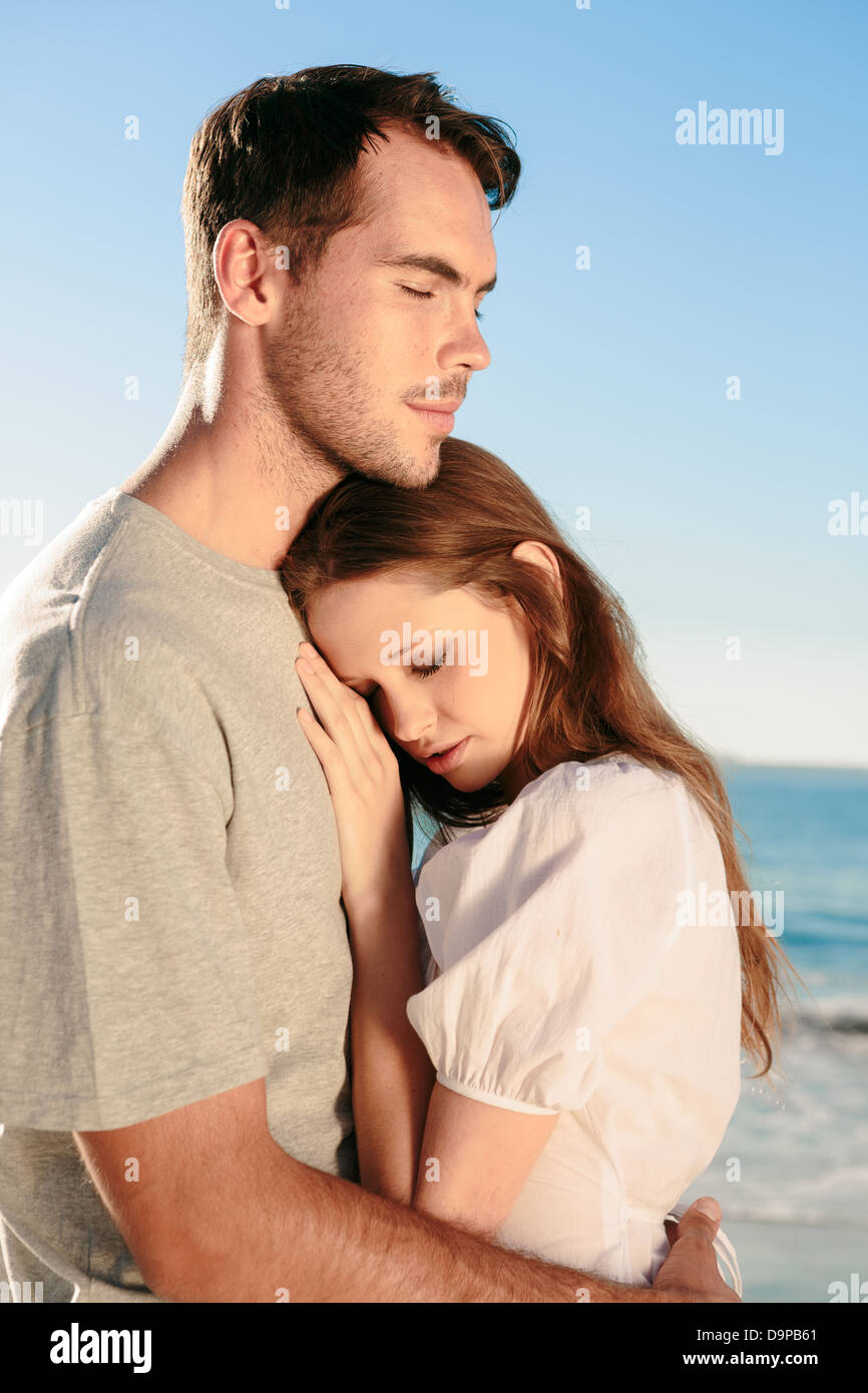 Cute couple relaxing on the beach Stock Photo - Alamy
