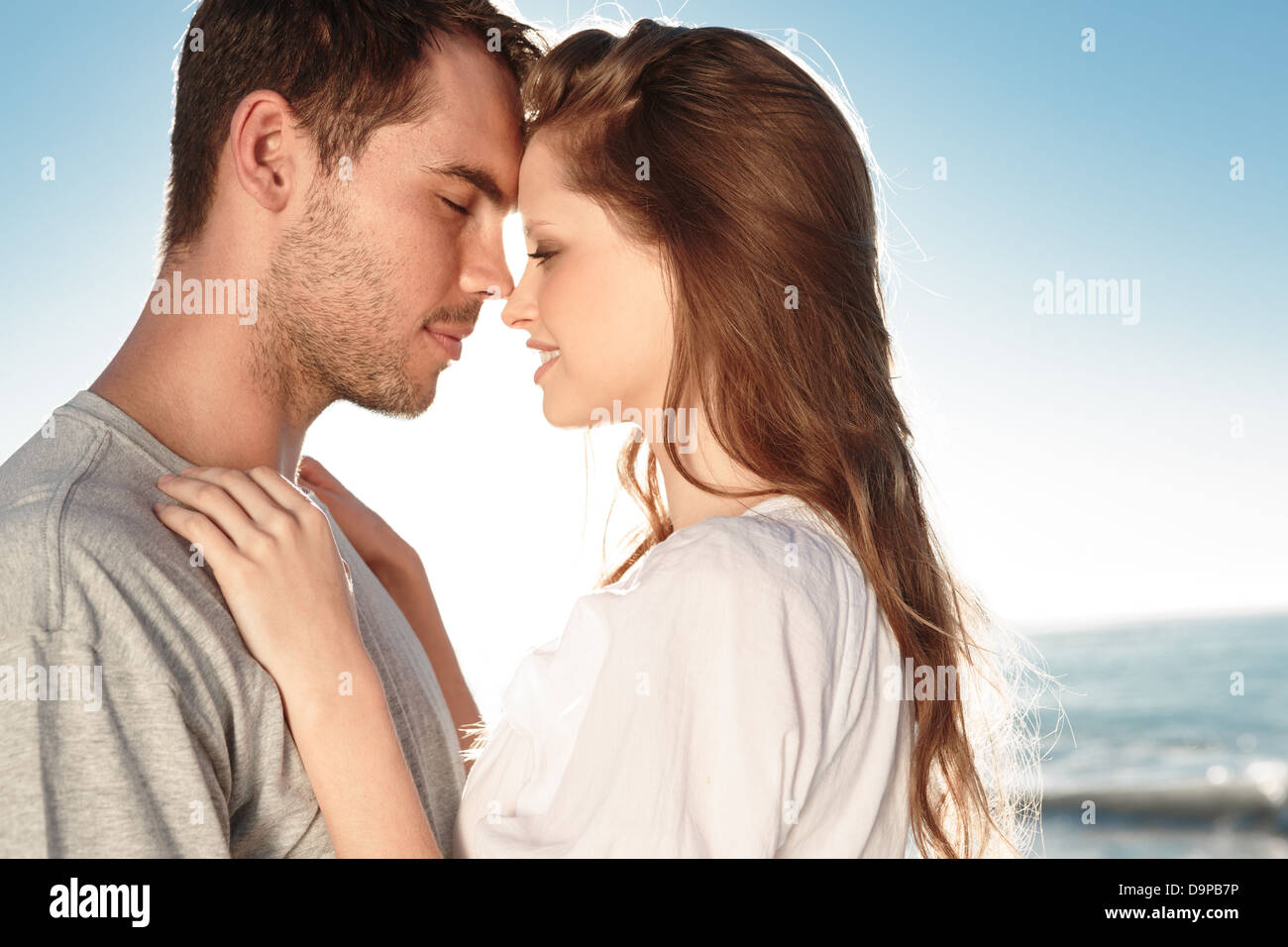 Attractive couple embracing on the beach Stock Photo - Alamy Attractive couple embracing on the beach Stock Photo - Alamy