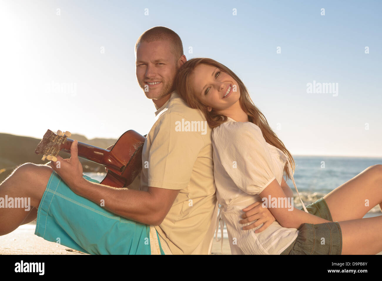 Cheerful Couple Sat Back To Back On The Beach Stock Photo Alamy cheerful-couple-sat-back-to-back-on-the-beach-stock-photo-alamy