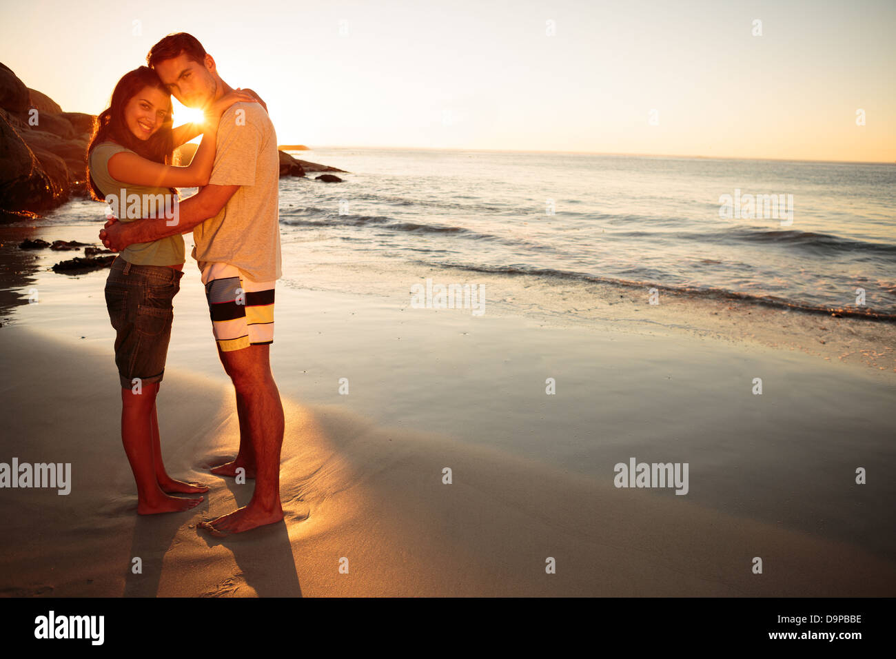 Lovers embracing on the beach Stock Photo - Alamy