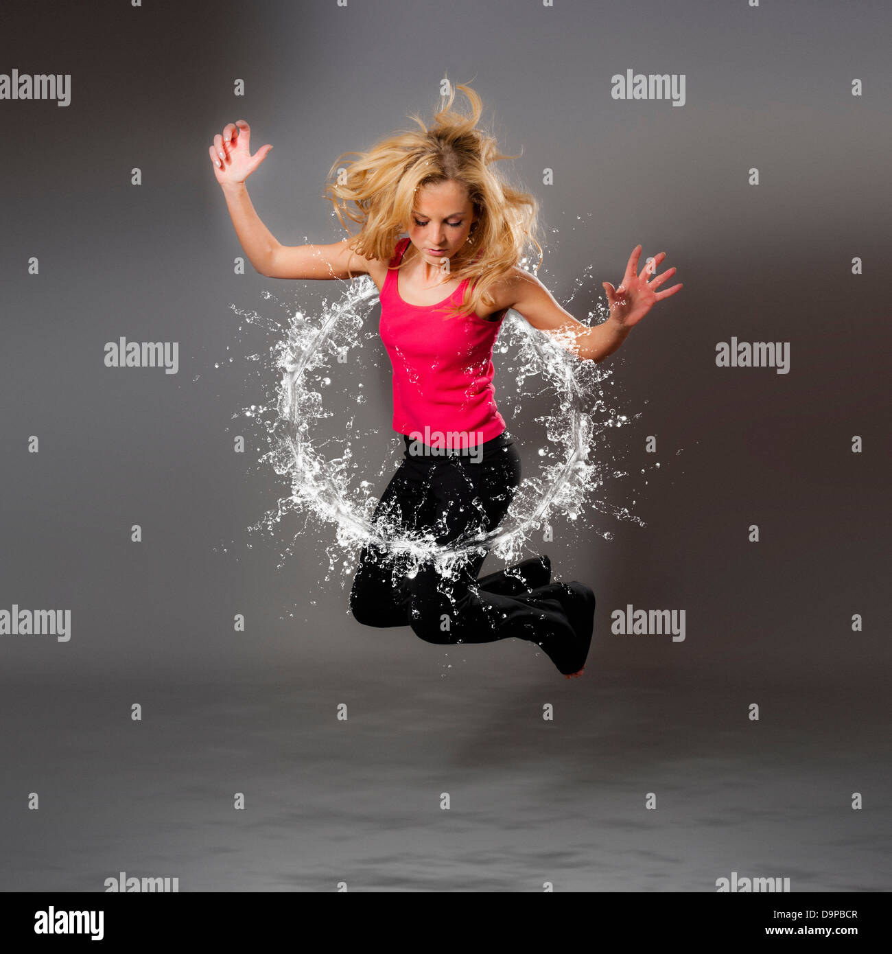 Composite shot of a young caucasian female jumping through a circular ...