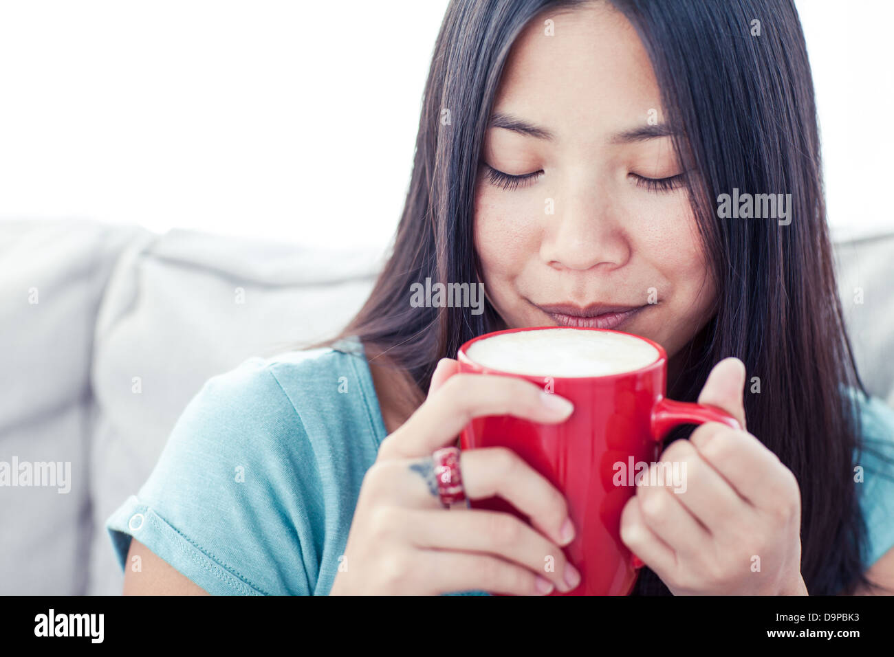 Asian woman drinking coffee Stock Photo - Alamy