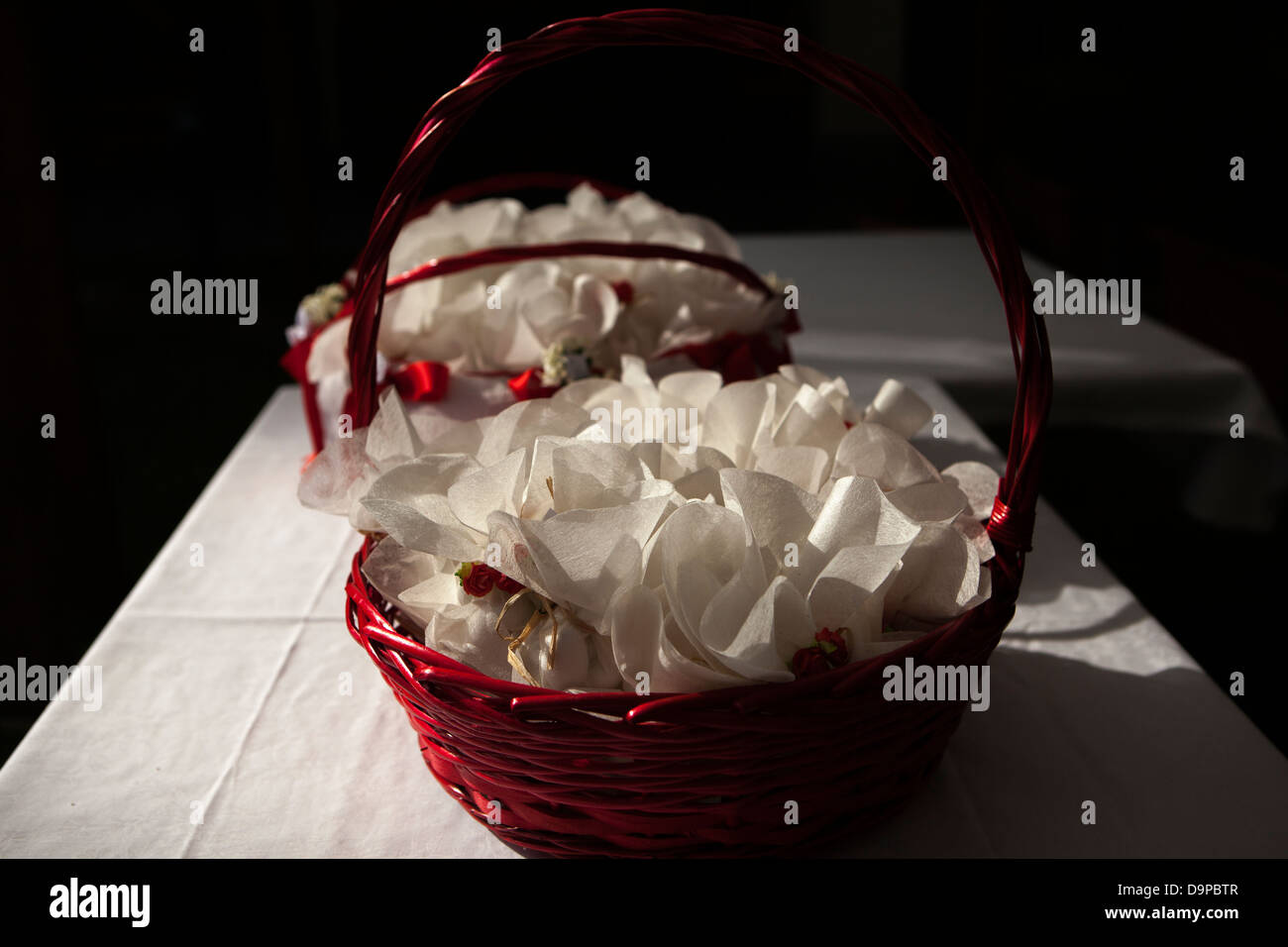 Red baskets of white party favors at wedding reception, close up Stock ...