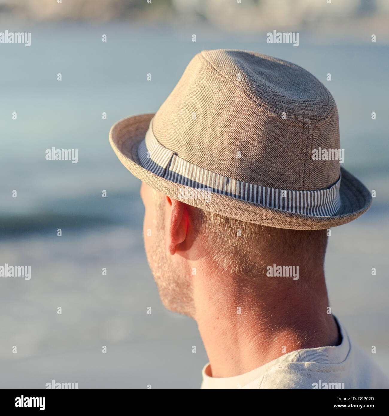 Relaxed man with a hat on the beach Stock Photo - Alamy