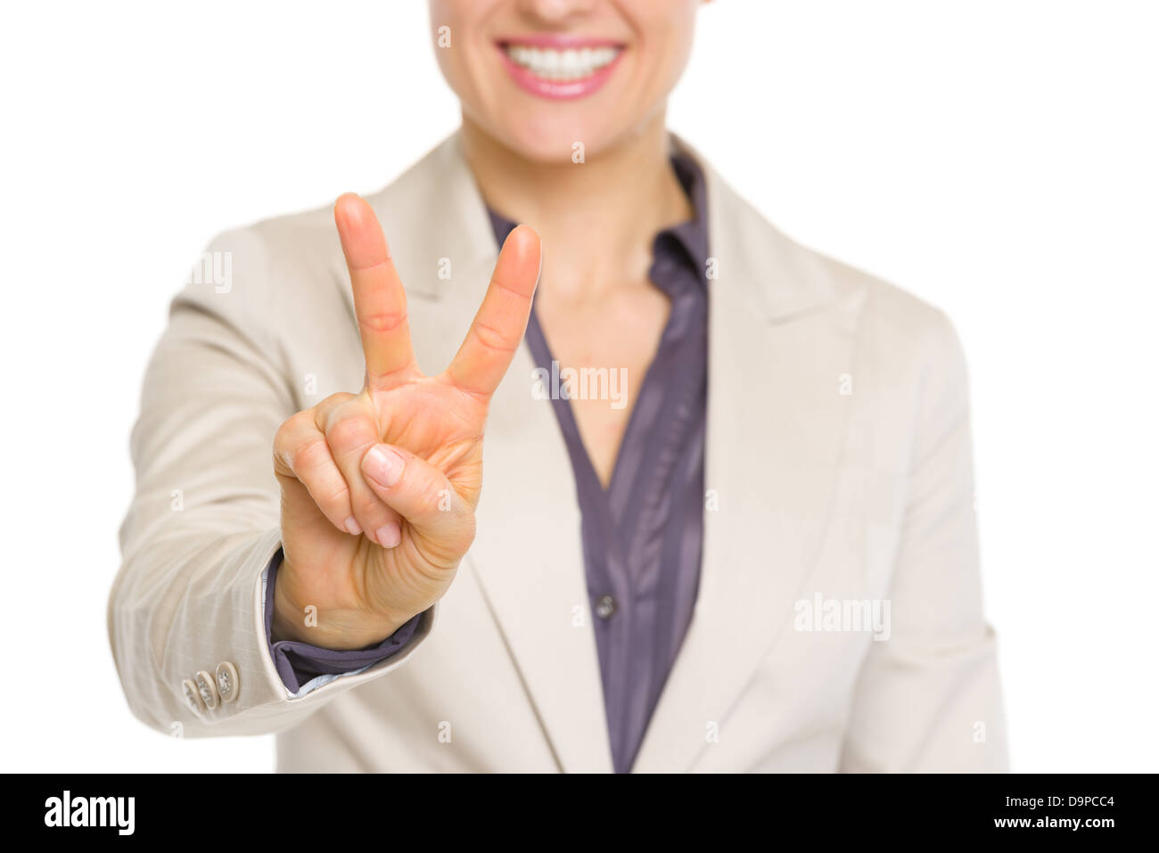 Closeup on smiling business woman showing victory gesture Stock Photo ...