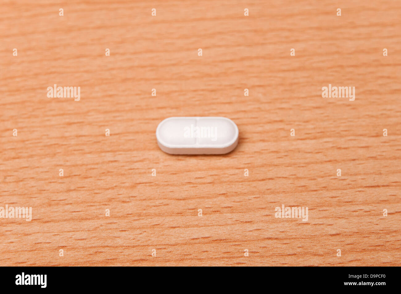 white colored tablet for headache or muscle aches Stock Photo - Alamy