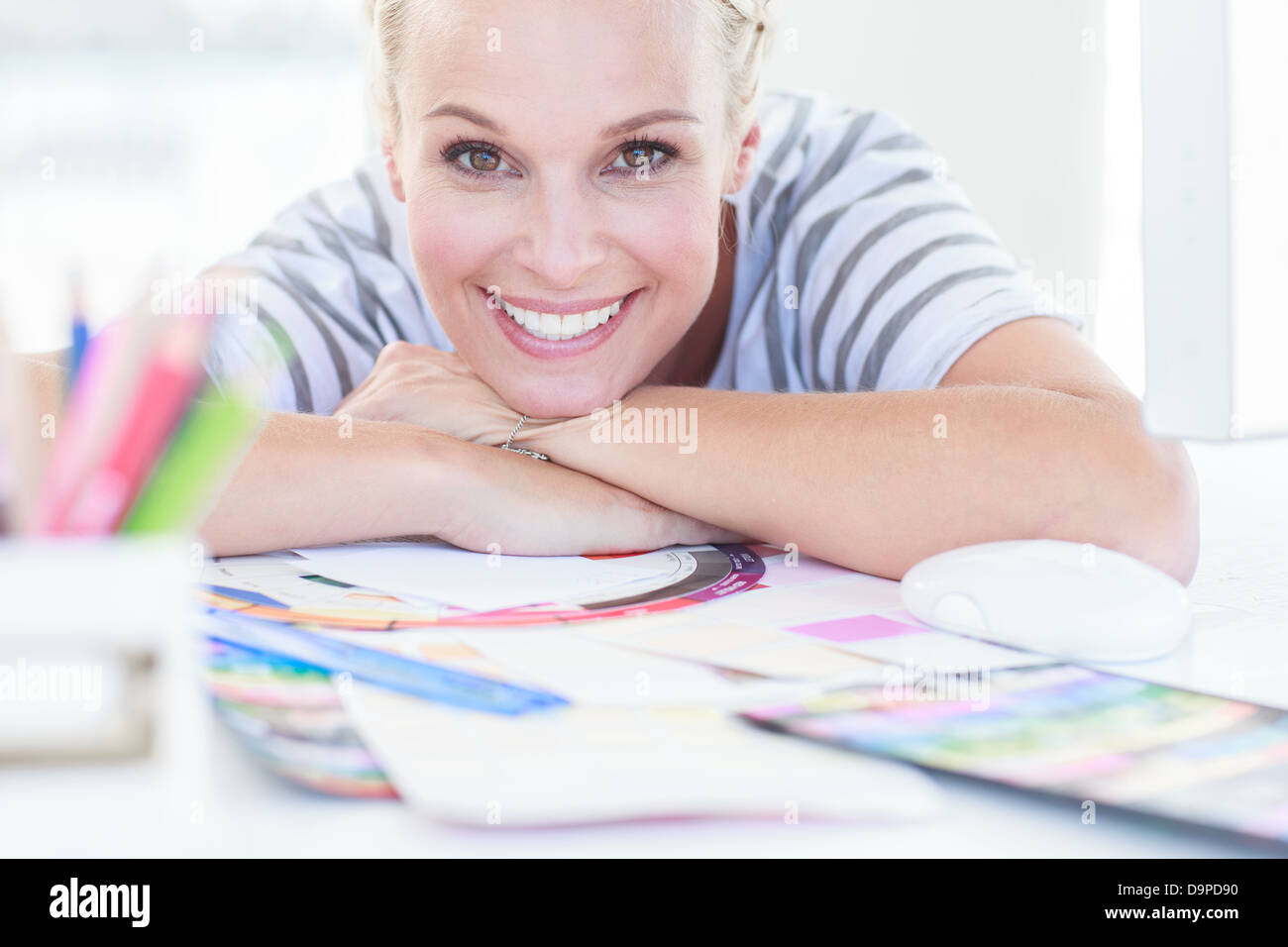 Female designer posing at her desk Stock Photo - Alamy
