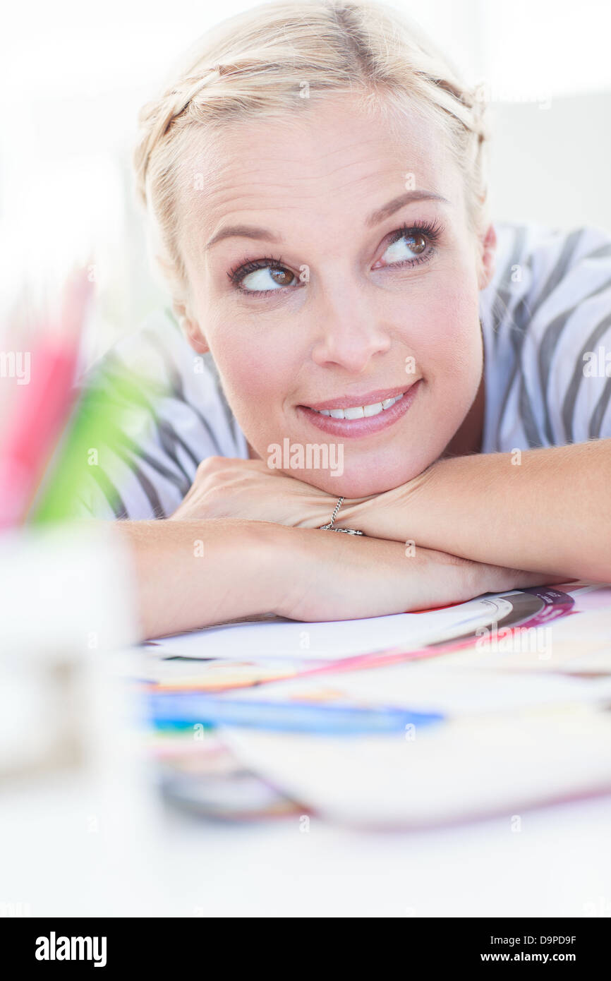 Happy designer posing on her desk Stock Photo - Alamy