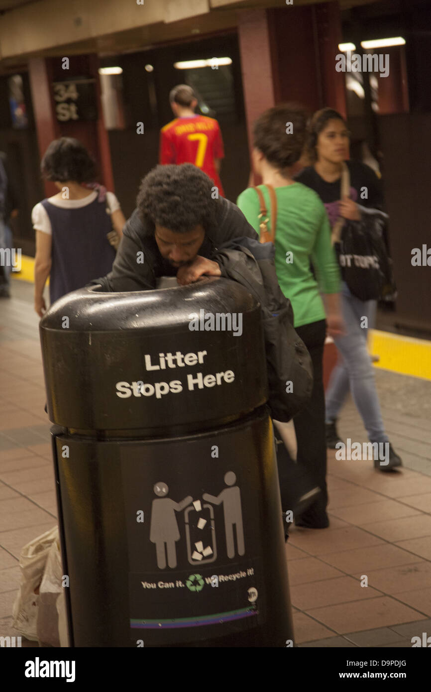 Man picks through the garbage looking for food on a 34th St. subway ...