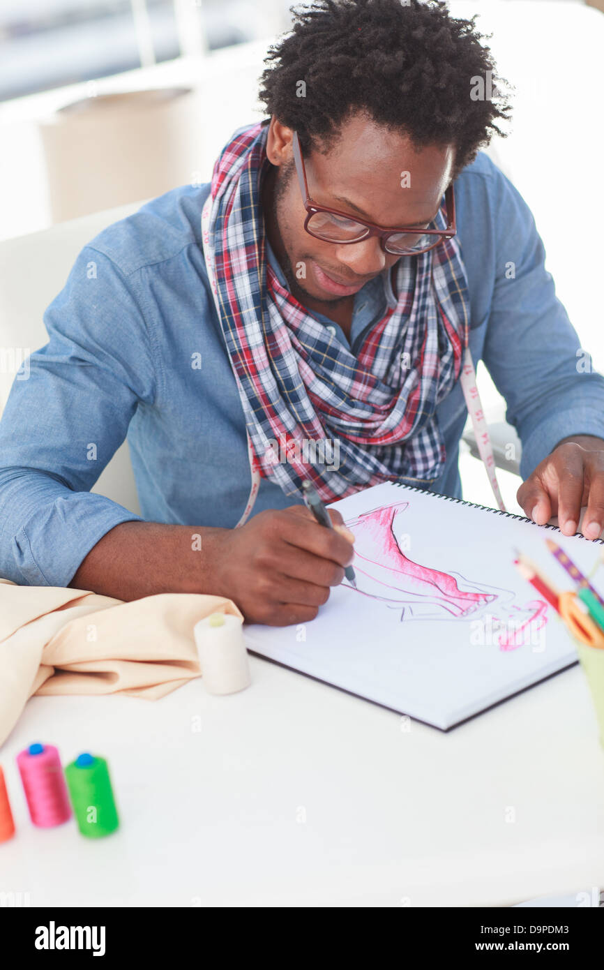 Concentrated artistic man with reading glasses drawing clothes Stock ...