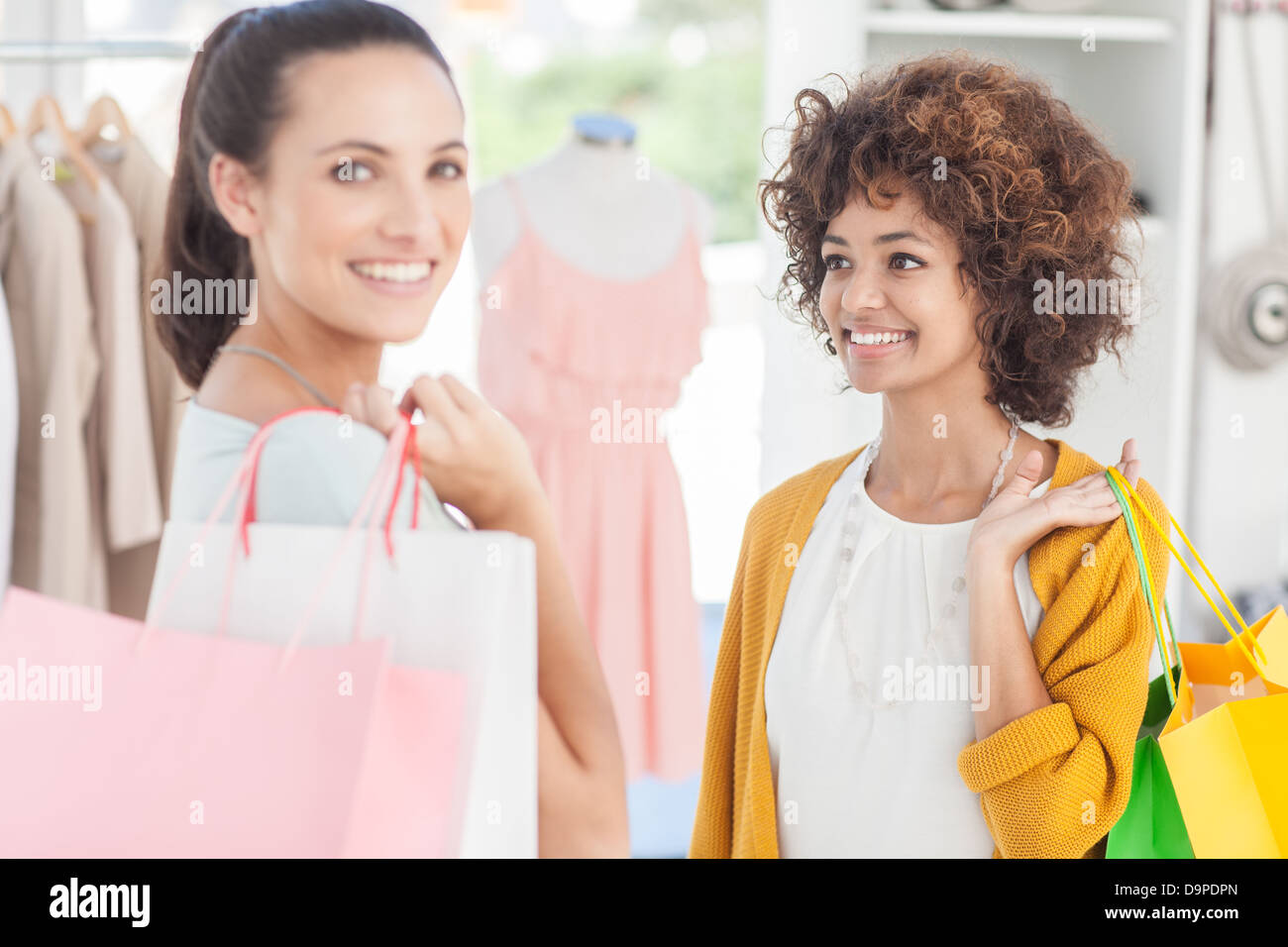 Two attractive friends in a clothing store Stock Photo - Alamy
