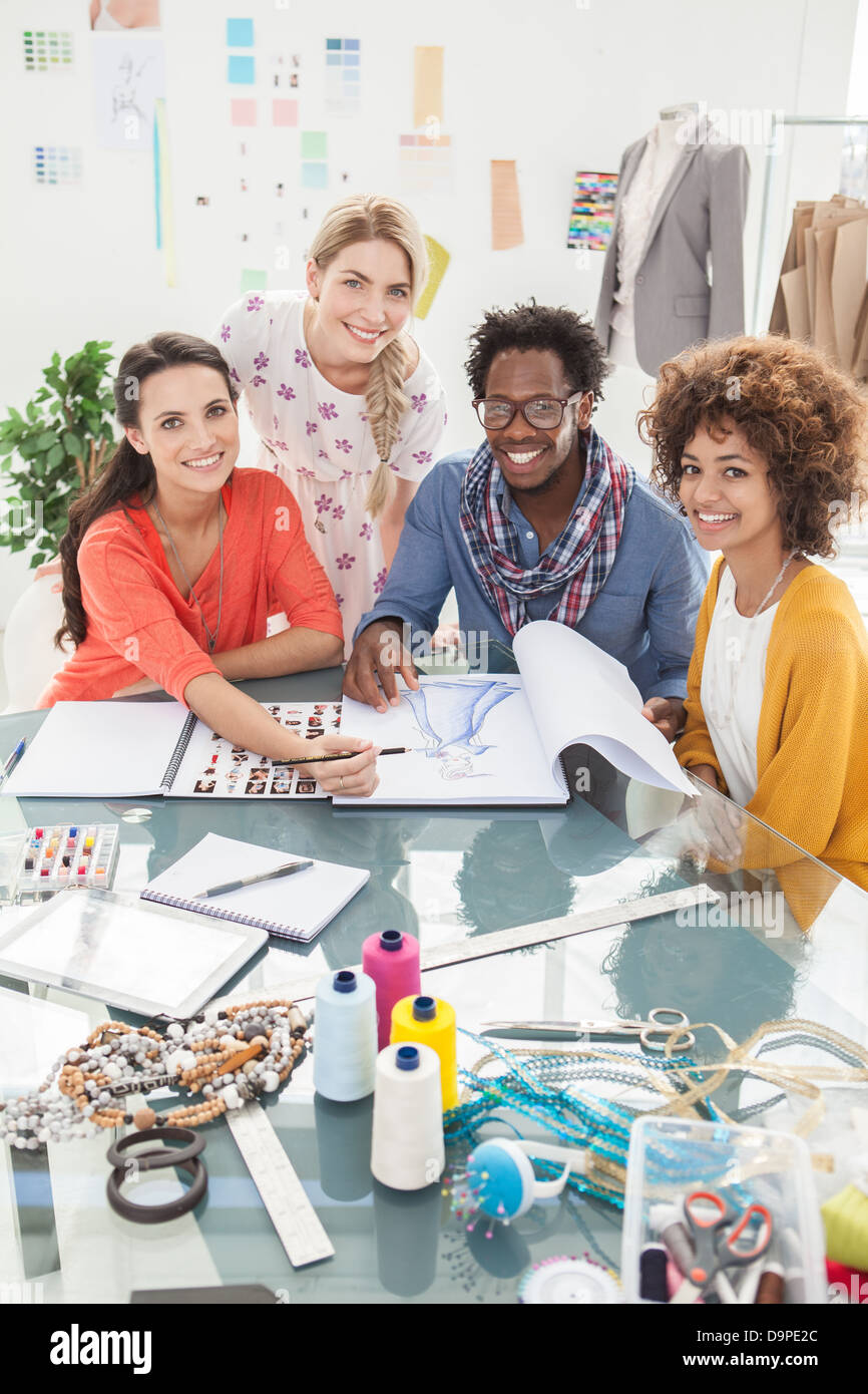 Smiling young fashion designers working together Stock Photo - Alamy