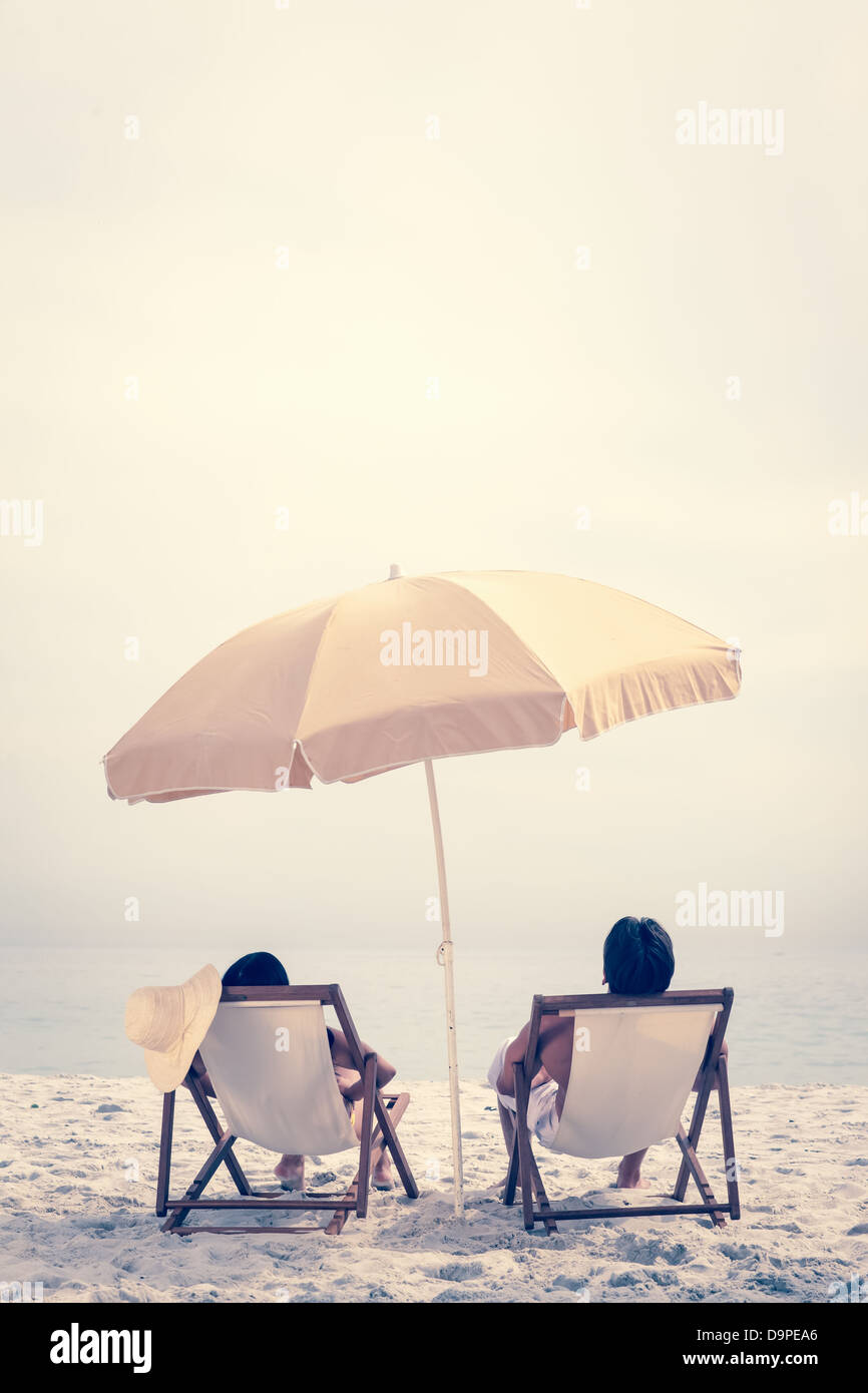 People relaxing on the beach reclining on deck chairs Stock Photo - Alamy