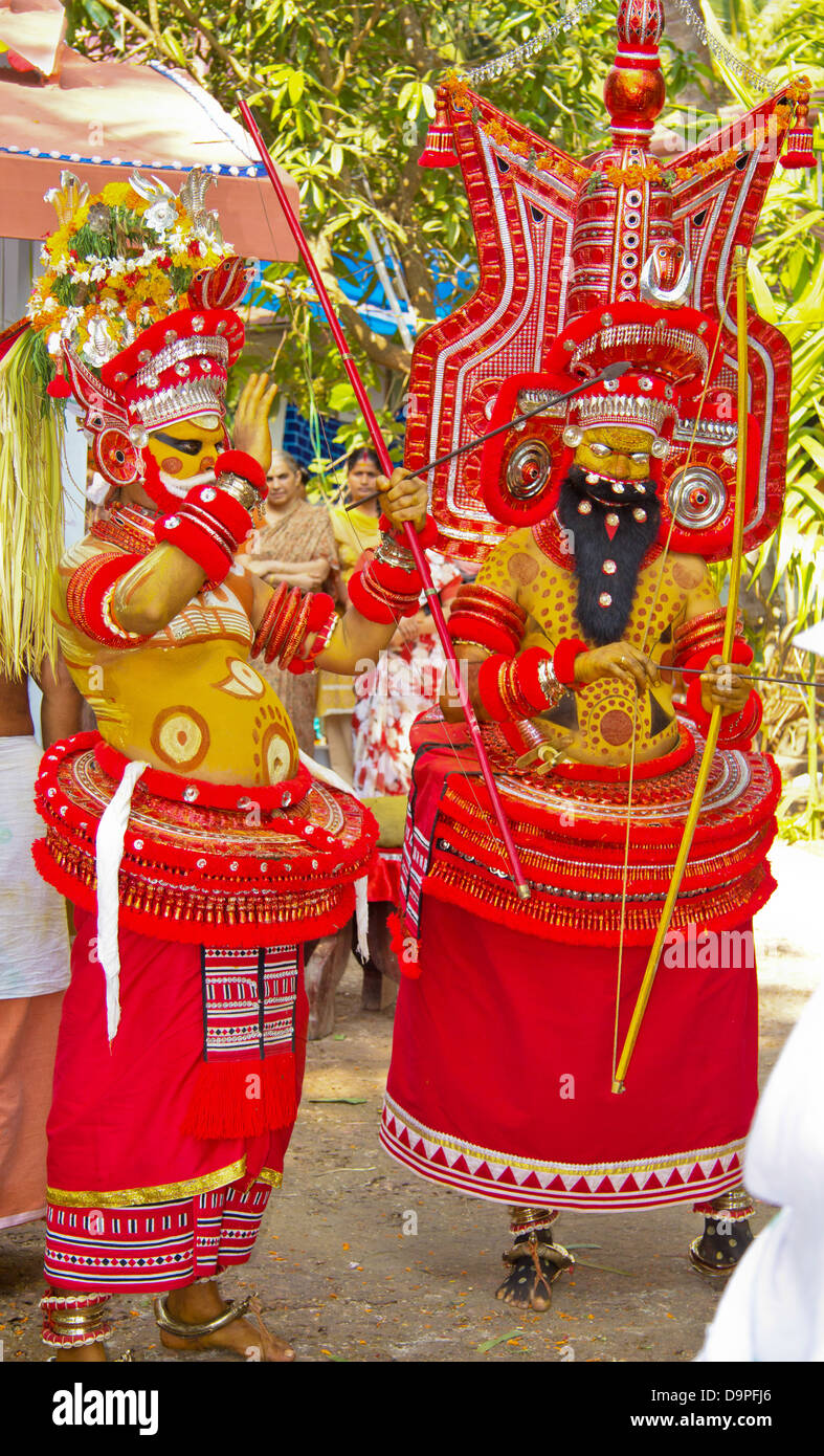 THEYYAM GODS WITH BOWS AND ARROWS ACTING IN A RELIGIOUS CEREMONY KANNUR ...